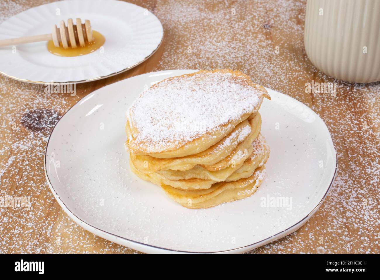 Homemade pancakes with honey, coffee on the table background. Sweet ...