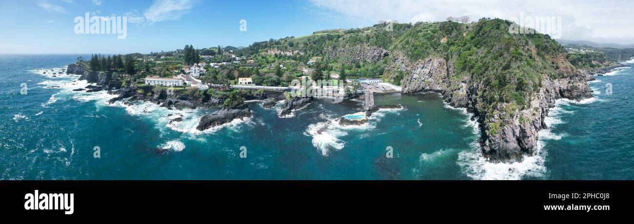 Drone view of the Caloura natural swimming pool, located in a seaside ...