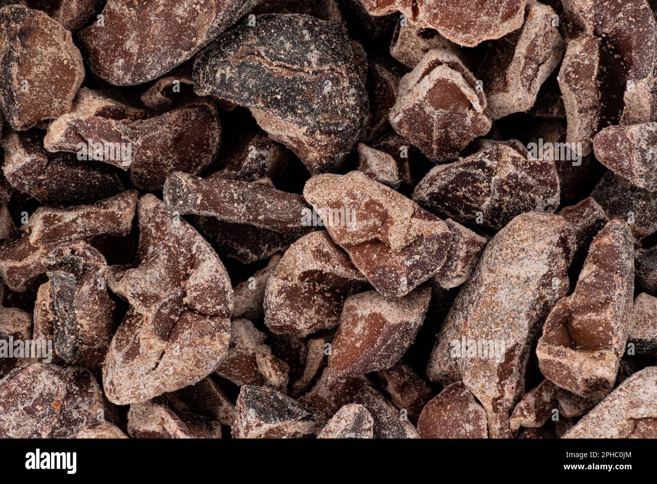 Pieces of broken cocoa beans - also called chocolate nibs, detail under ...