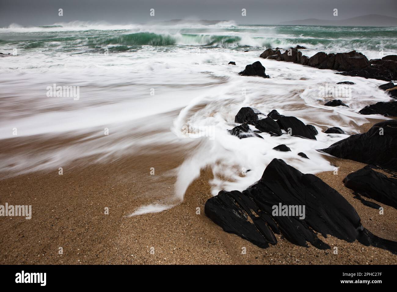 Wave receding down beach Stock Photo - Alamy
