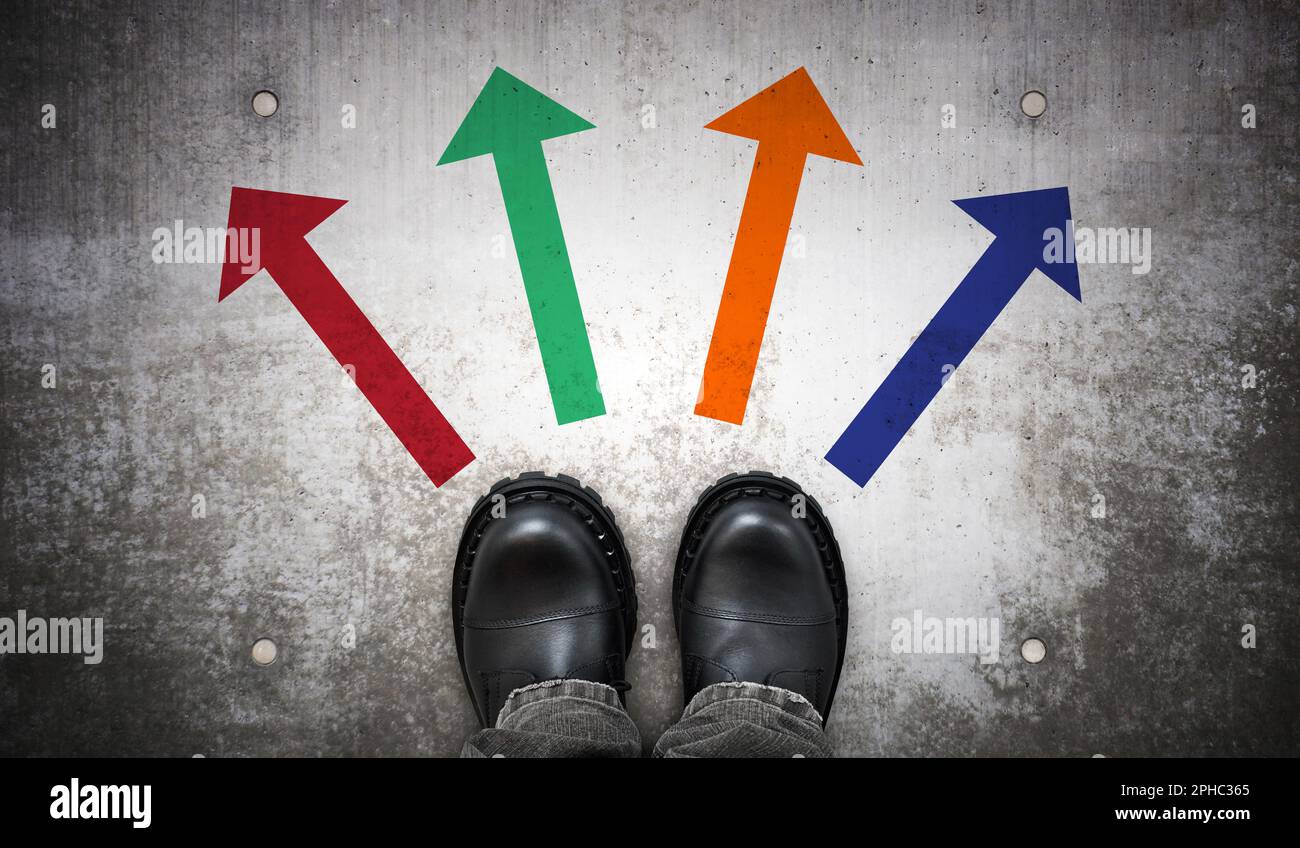 Heavy black leather boots and colorful four chalky arrows on ground ...
