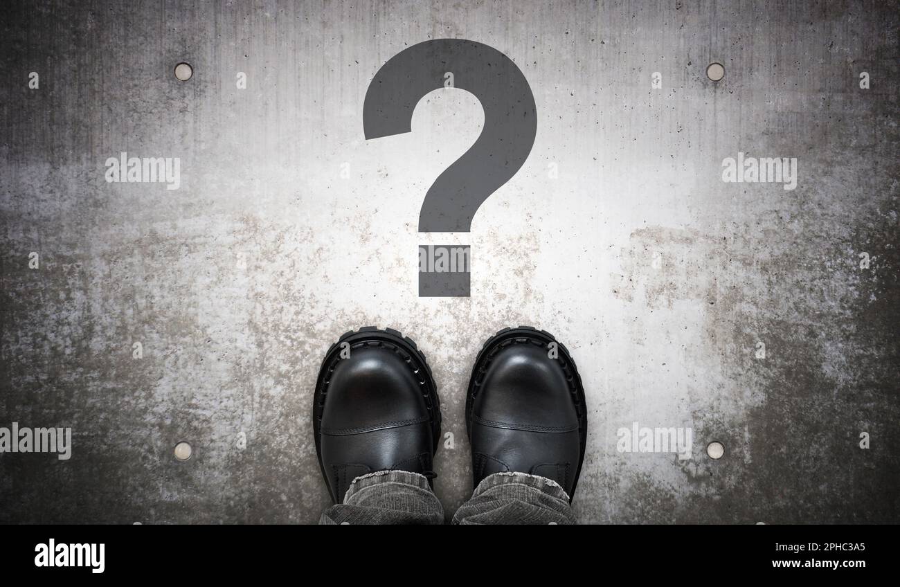 Heavy black leather boots and white question mark - problem concept ...