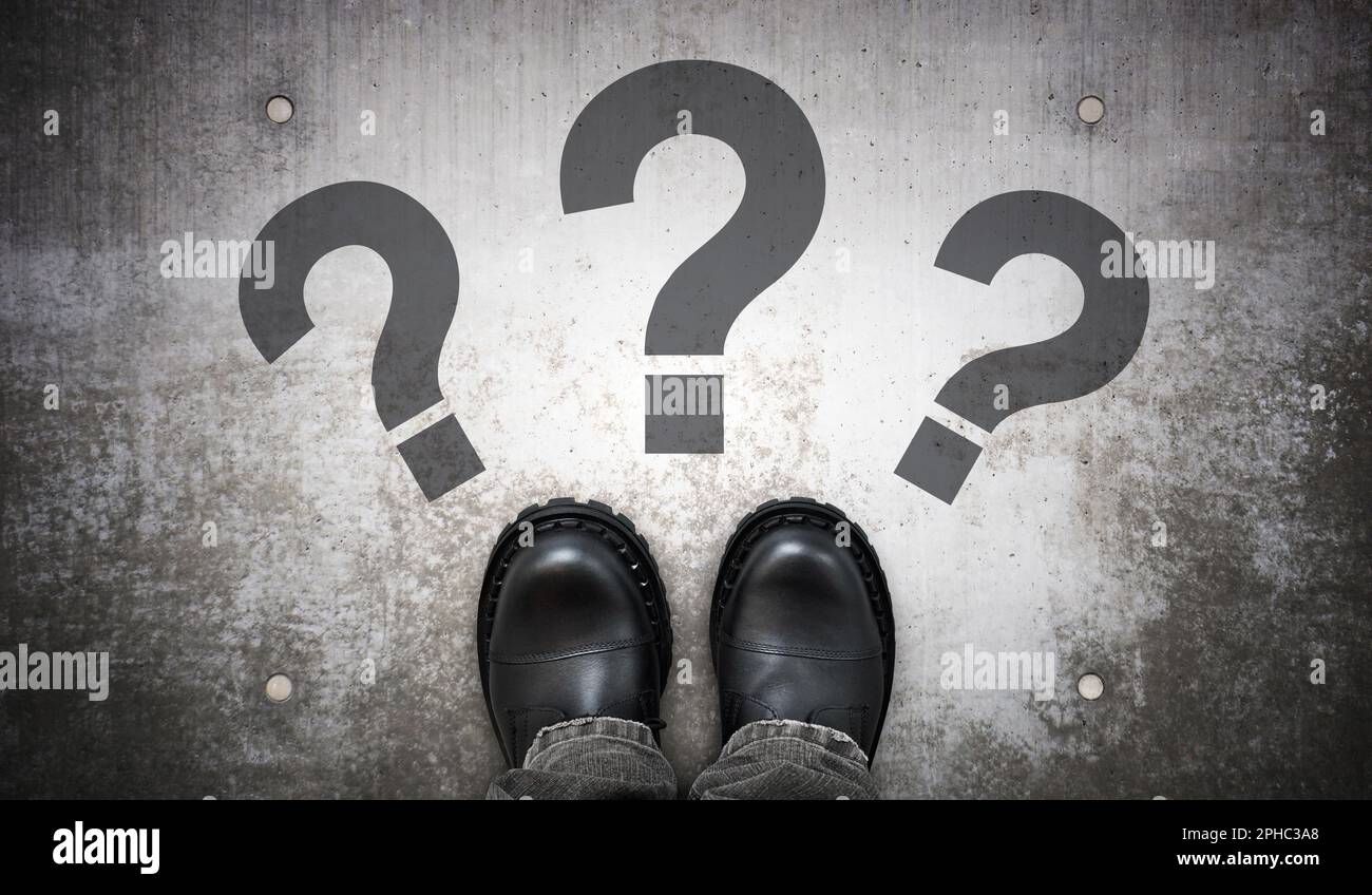 Heavy black leather boots and three question marks - problem concept ...