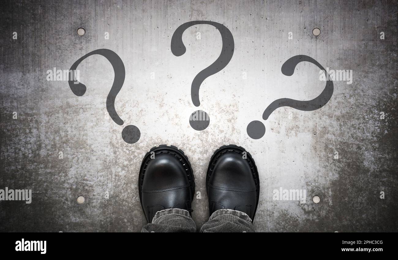 Heavy black leather boots and three question marks - problem concept ...