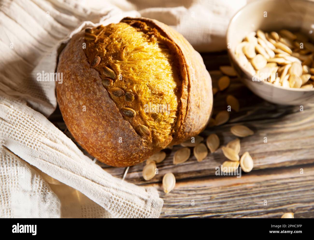 Bread; traditional sourdough bread; round shape with pumpkin seeds on a ...