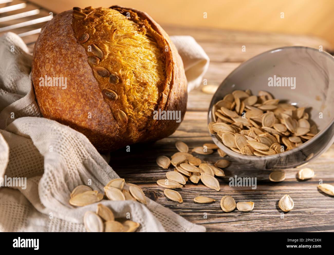 Bread; traditional sourdough bread; round shape with pumpkin seeds on a ...