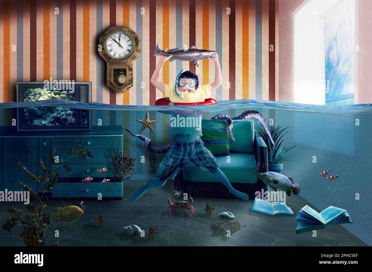 Creative boy making the most of his flooded home by catching a fish and ...