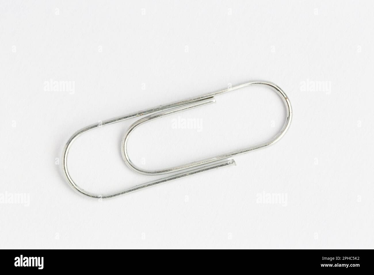 Paper clip on a white background Stock Photo - Alamy