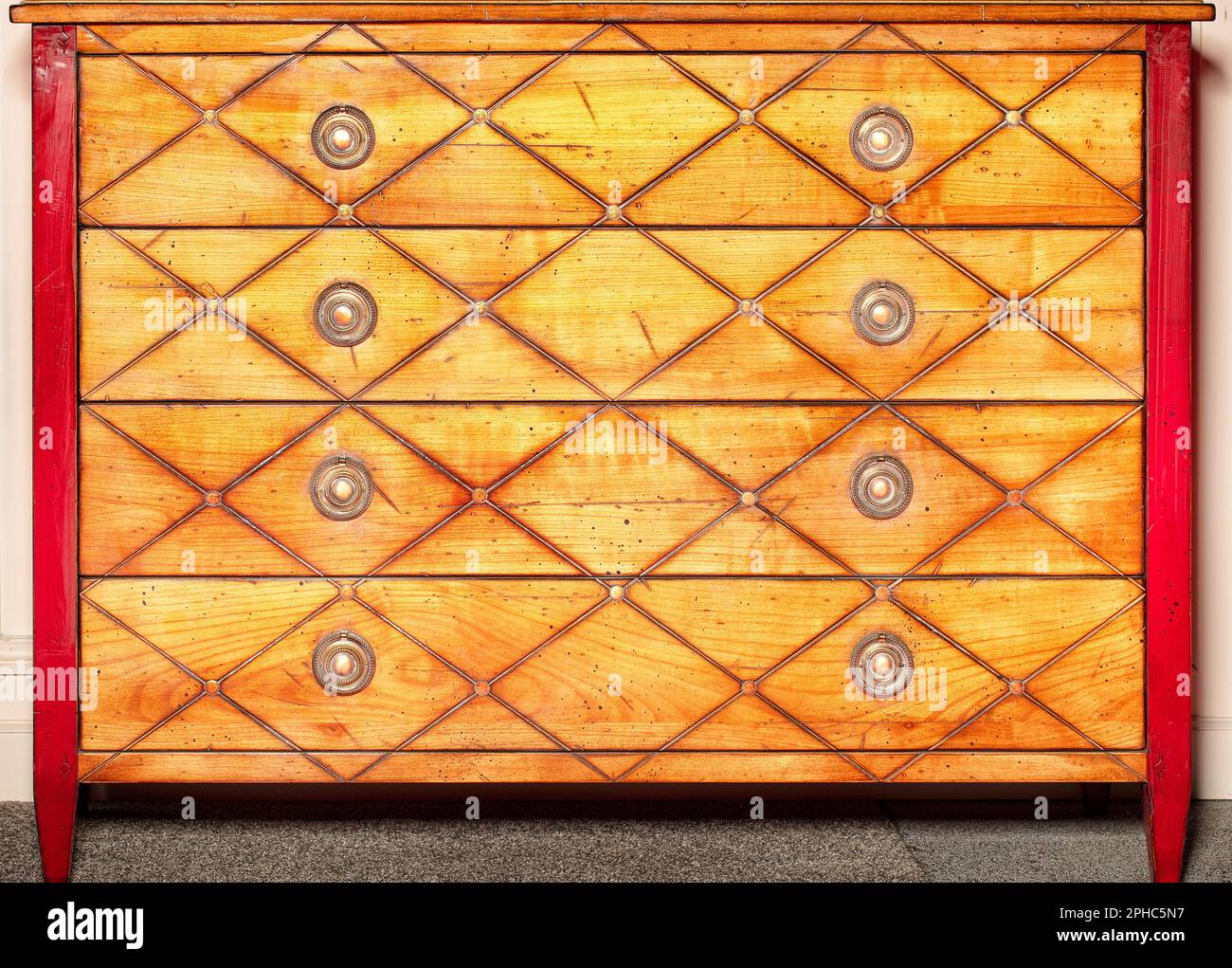 Vintage chest of drawers in bright orange with symmetrical patterns and ...