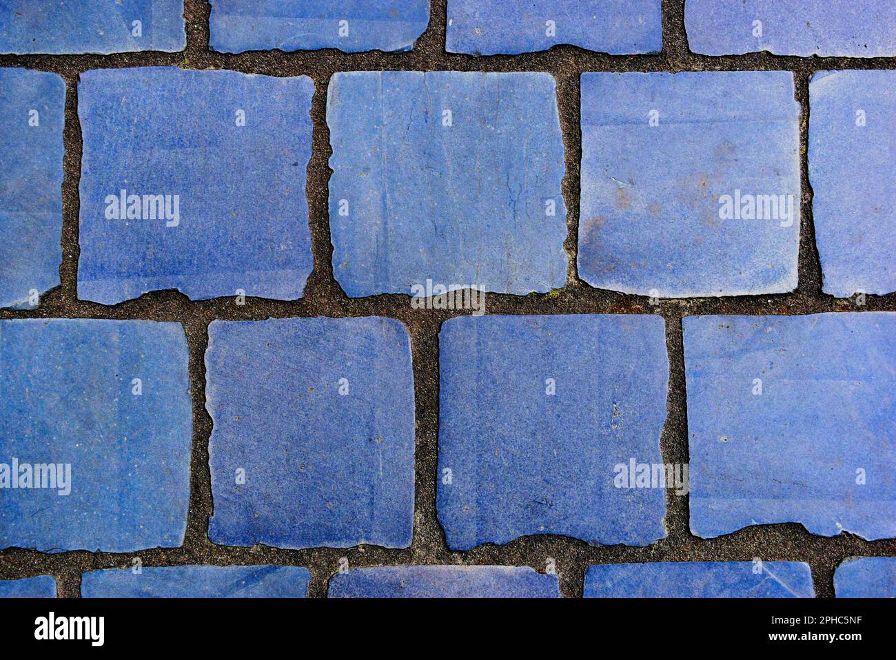 gray cobblestone pavement closeup. smooth sawcut stone surface with ...