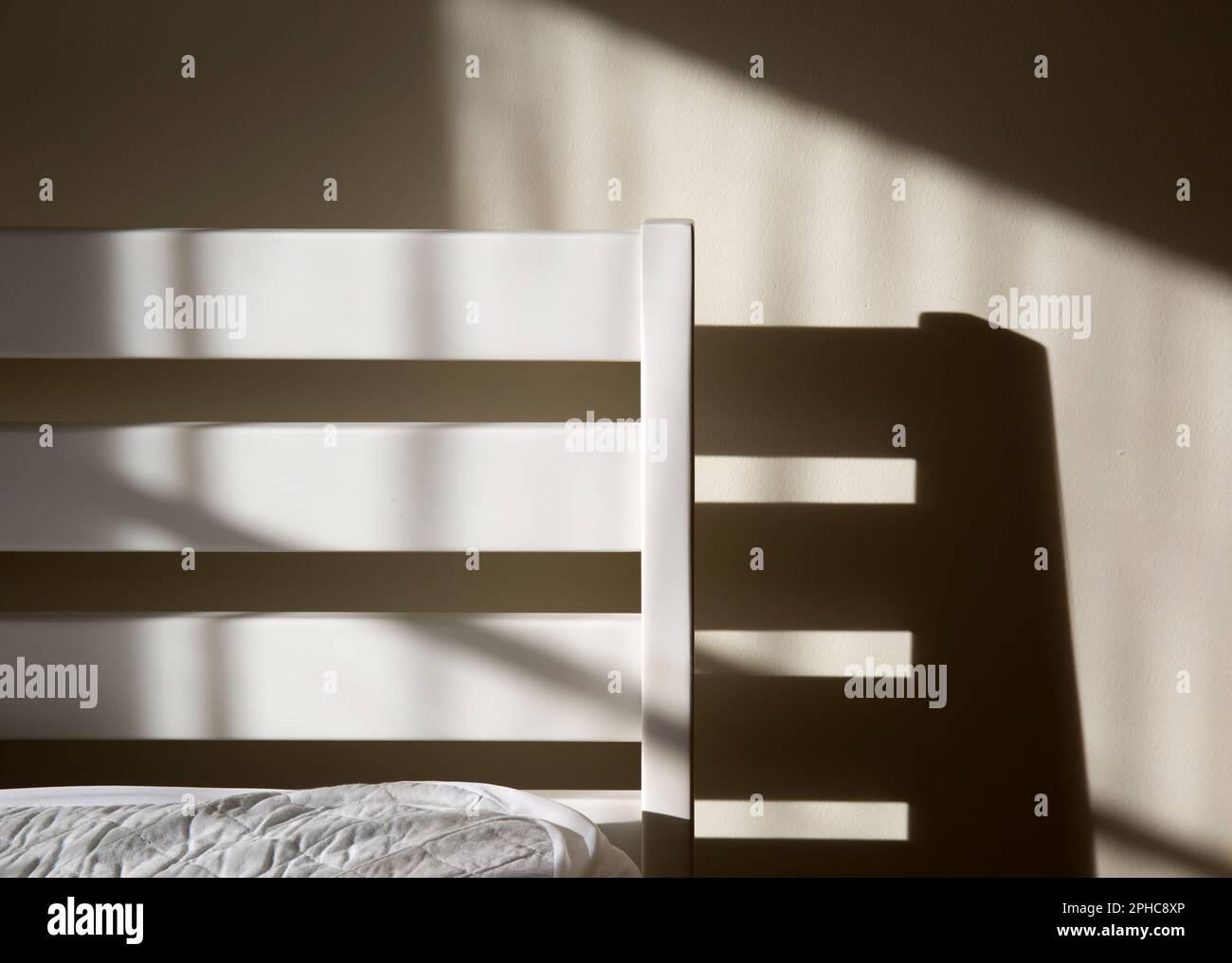 Bed Headboard Lit by Morning Sunshine Stock Photo - Alamy