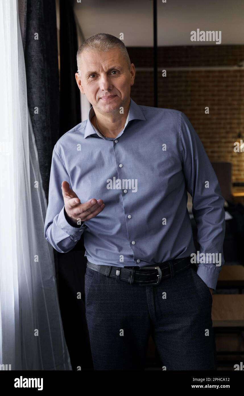 Close-up portrait of a middle-aged business man who shows a suggestion ...