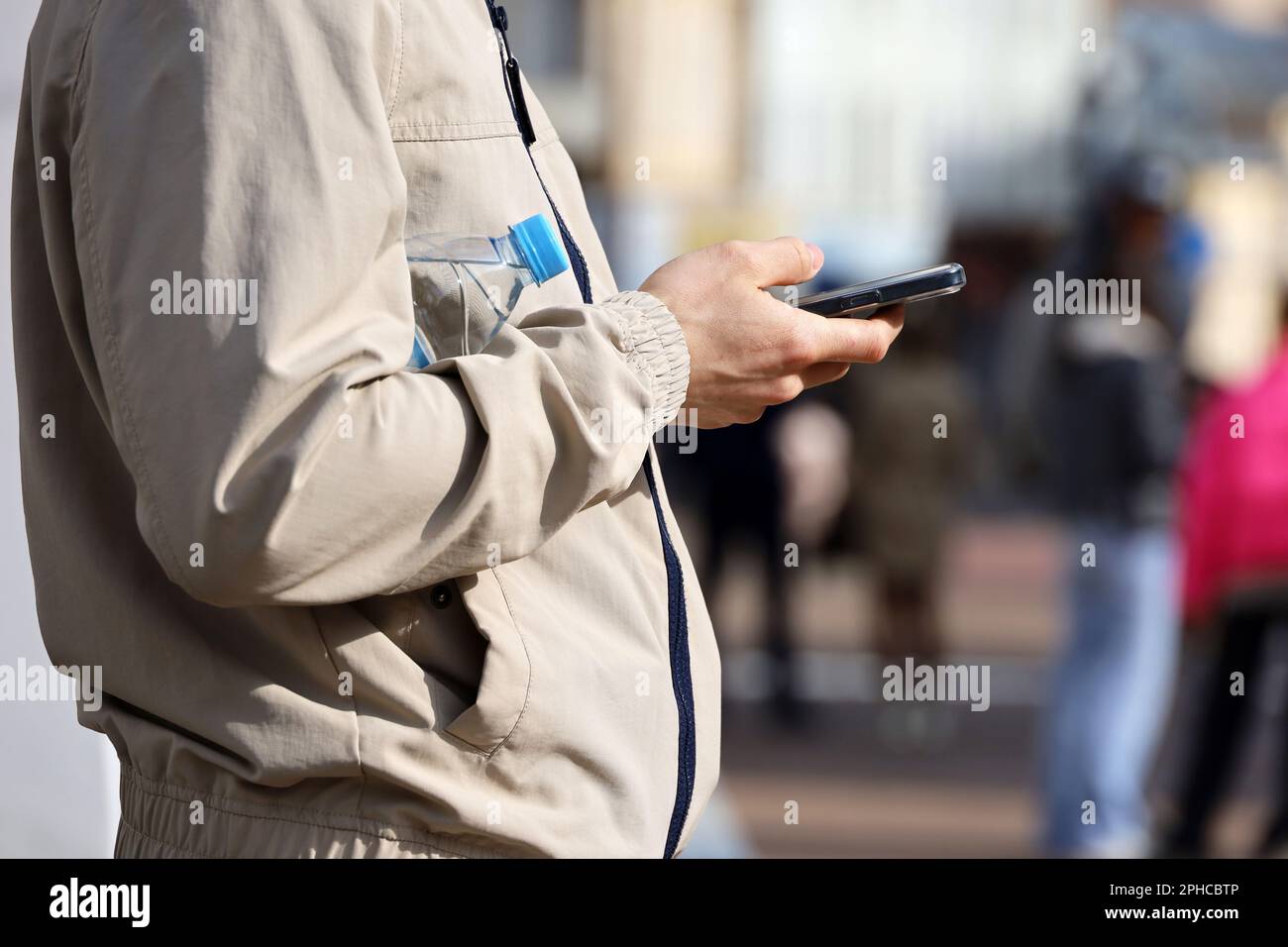 Male hands with smartphone close up on blurred people background. Man ...