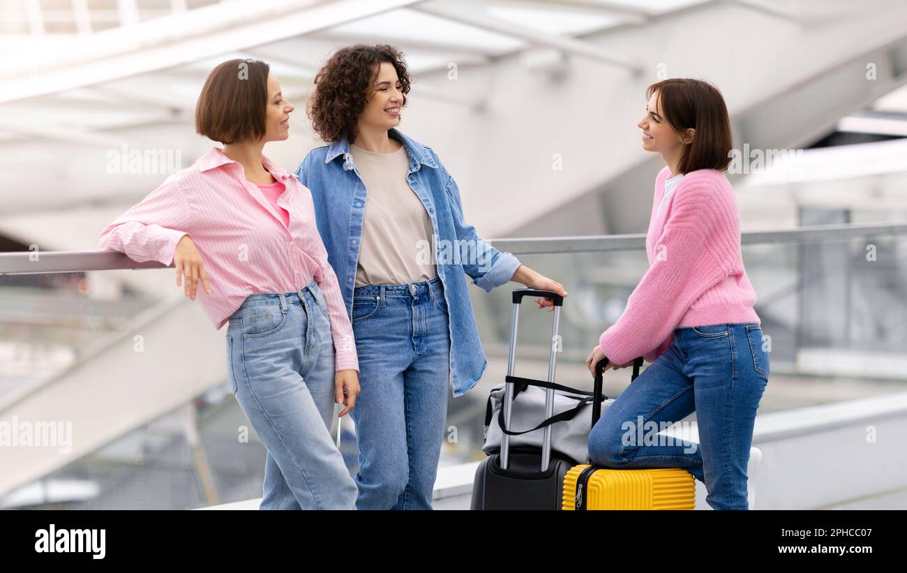 Three Beautiful Women Chatting While Waiting Flight At Airport Stock ...