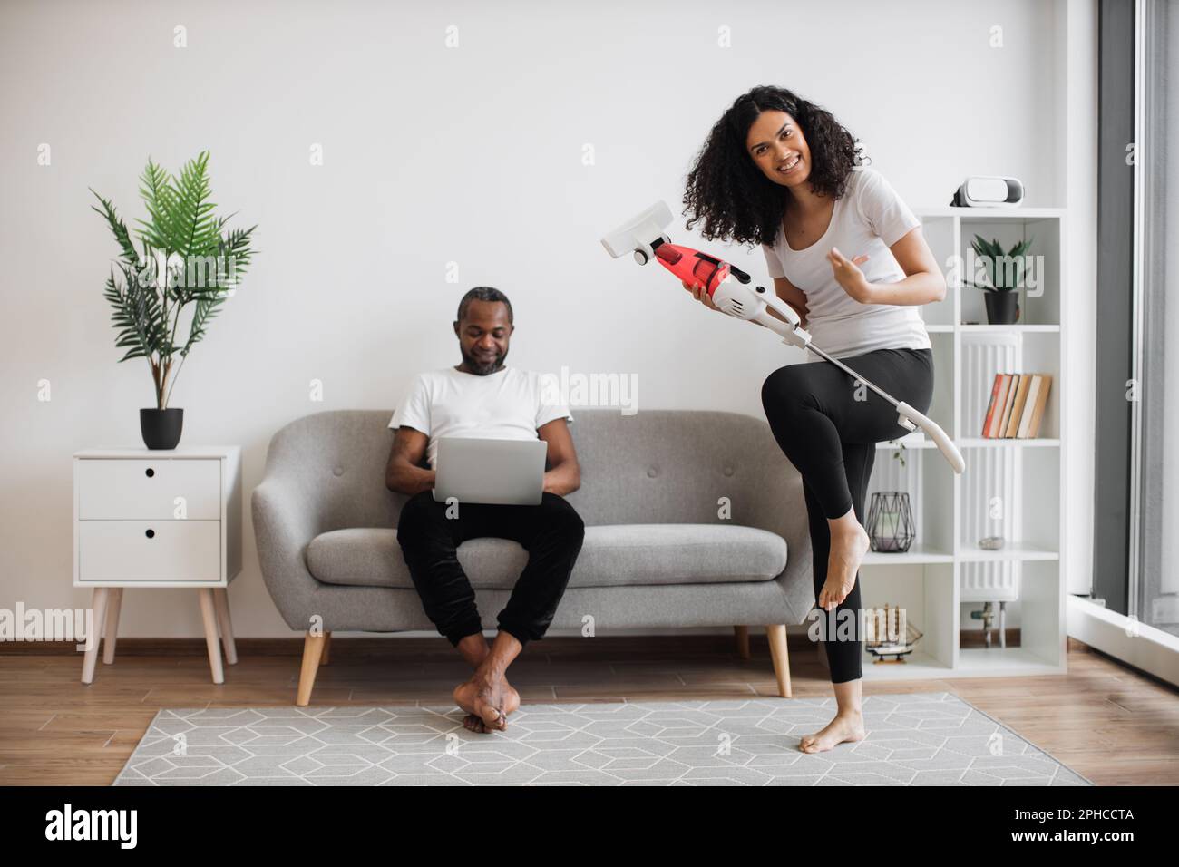 Woman dancing cordless vacuum hi-res stock photography and images - Alamy