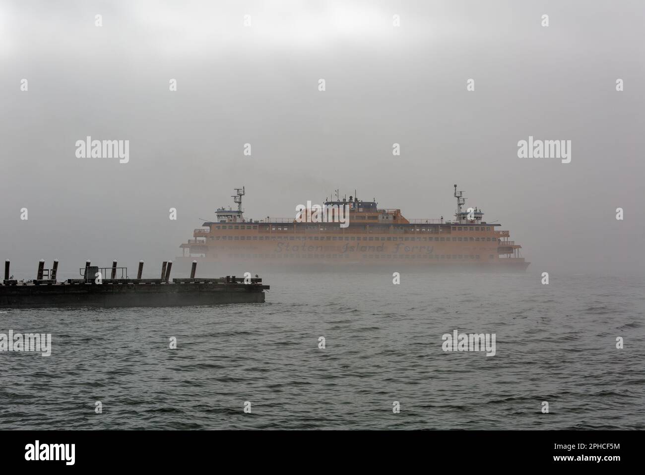 The Staten Island Ferry is the only spot of color on a foggy February ...