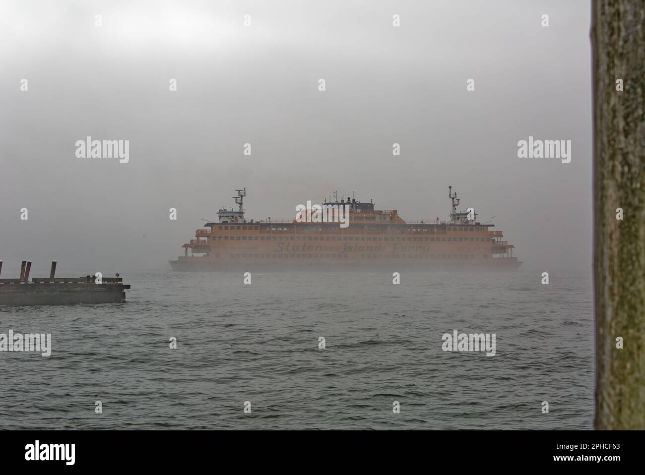 The Staten Island Ferry is the only spot of color on a foggy February ...