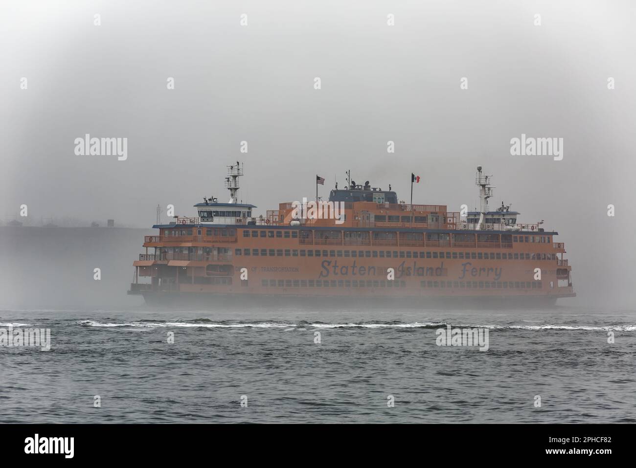 The Staten Island Ferry is the only spot of color on a foggy February ...