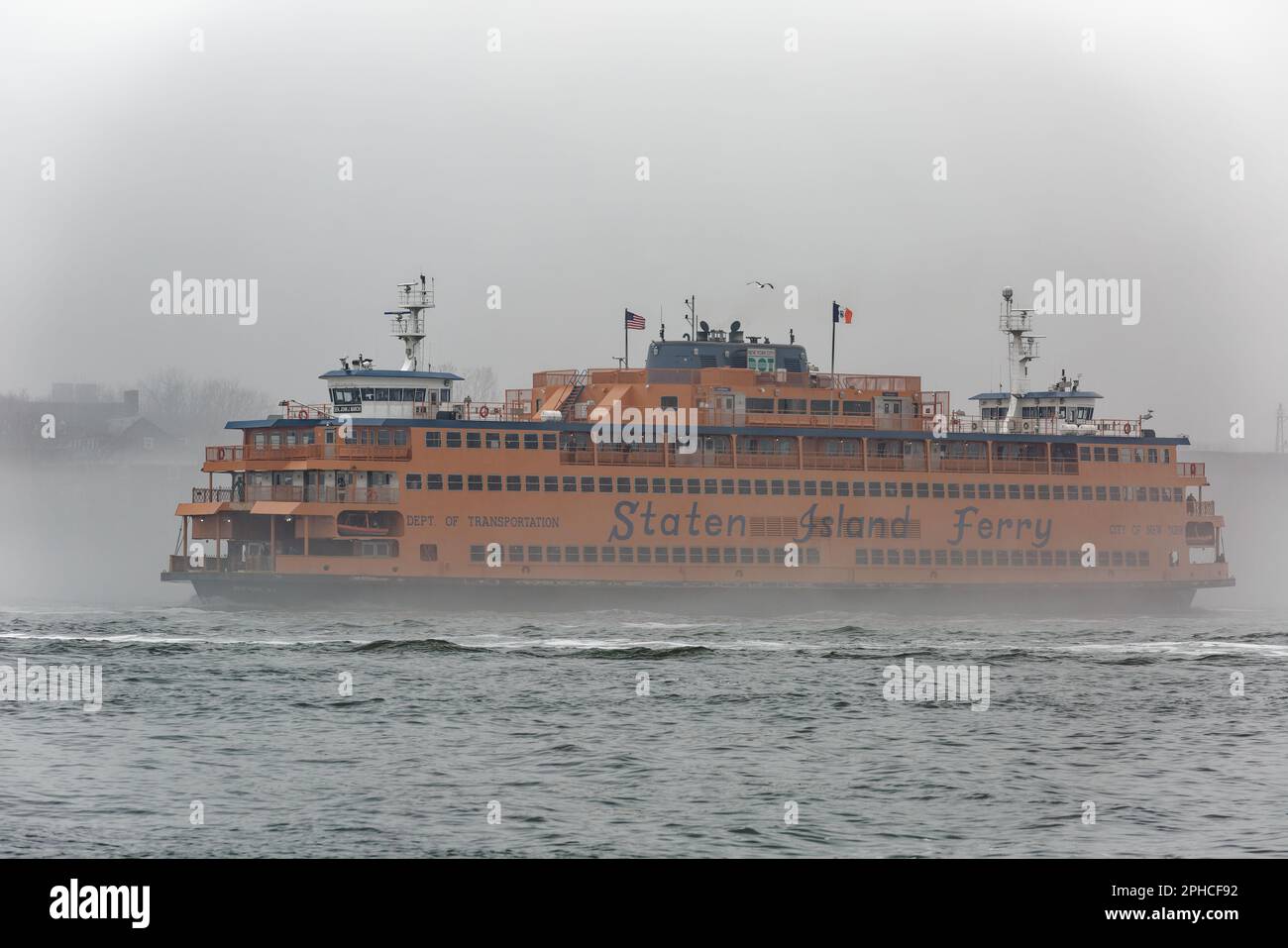 The Staten Island Ferry is the only spot of color on a foggy February ...