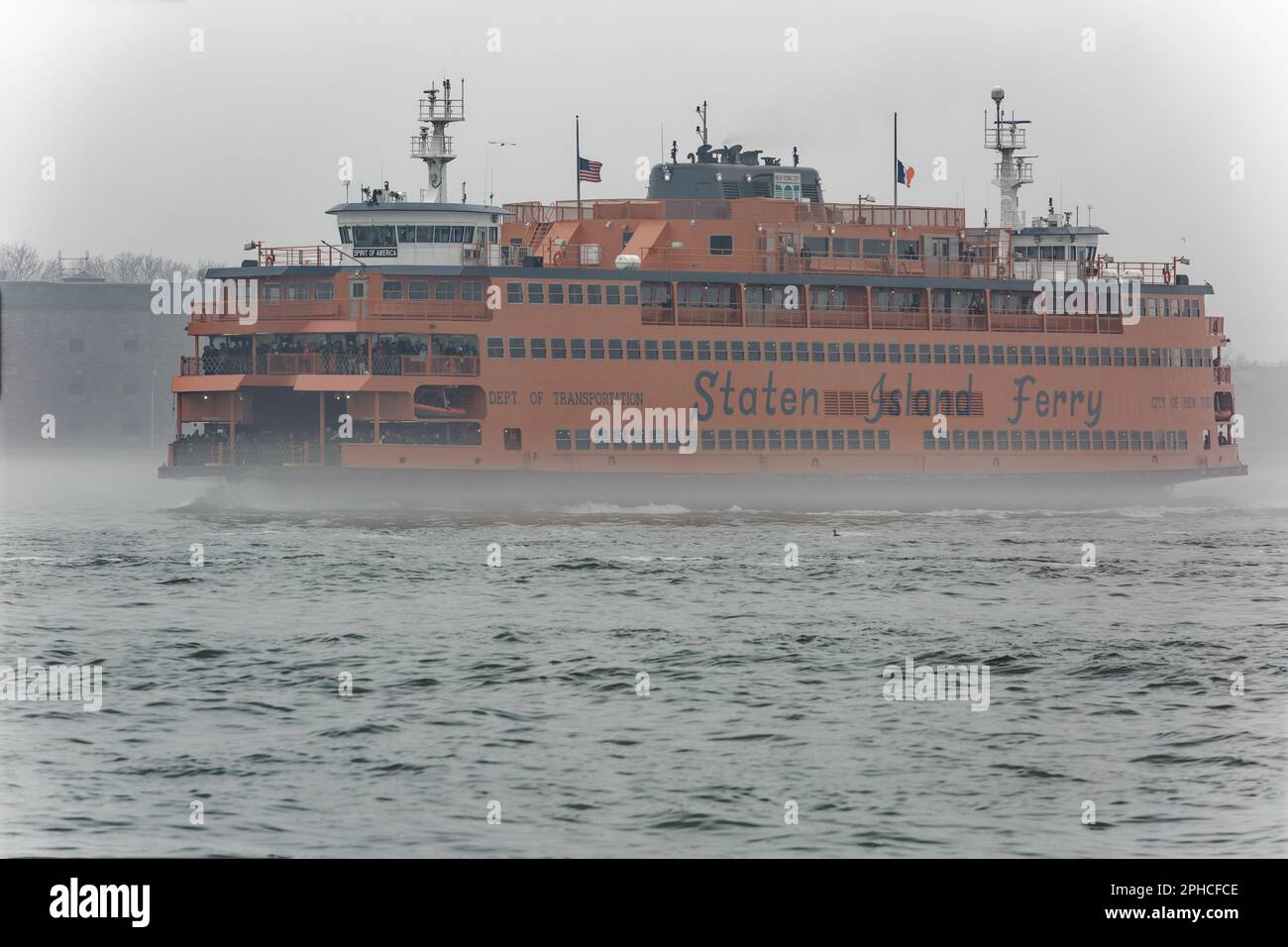 The Staten Island Ferry is the only spot of color on a foggy February ...