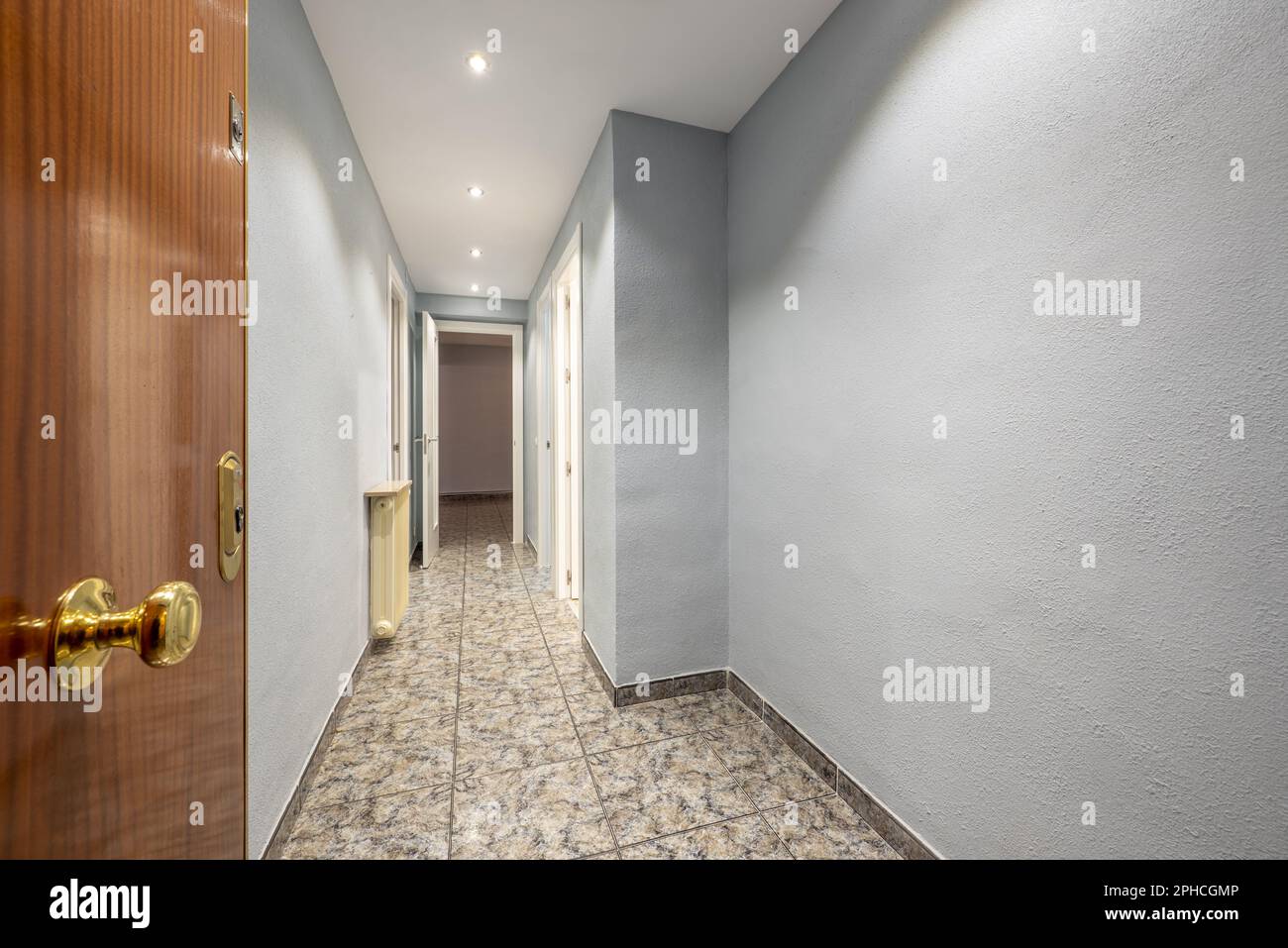 Entrance hall of a house with a long hallway with blue-gray painted ...
