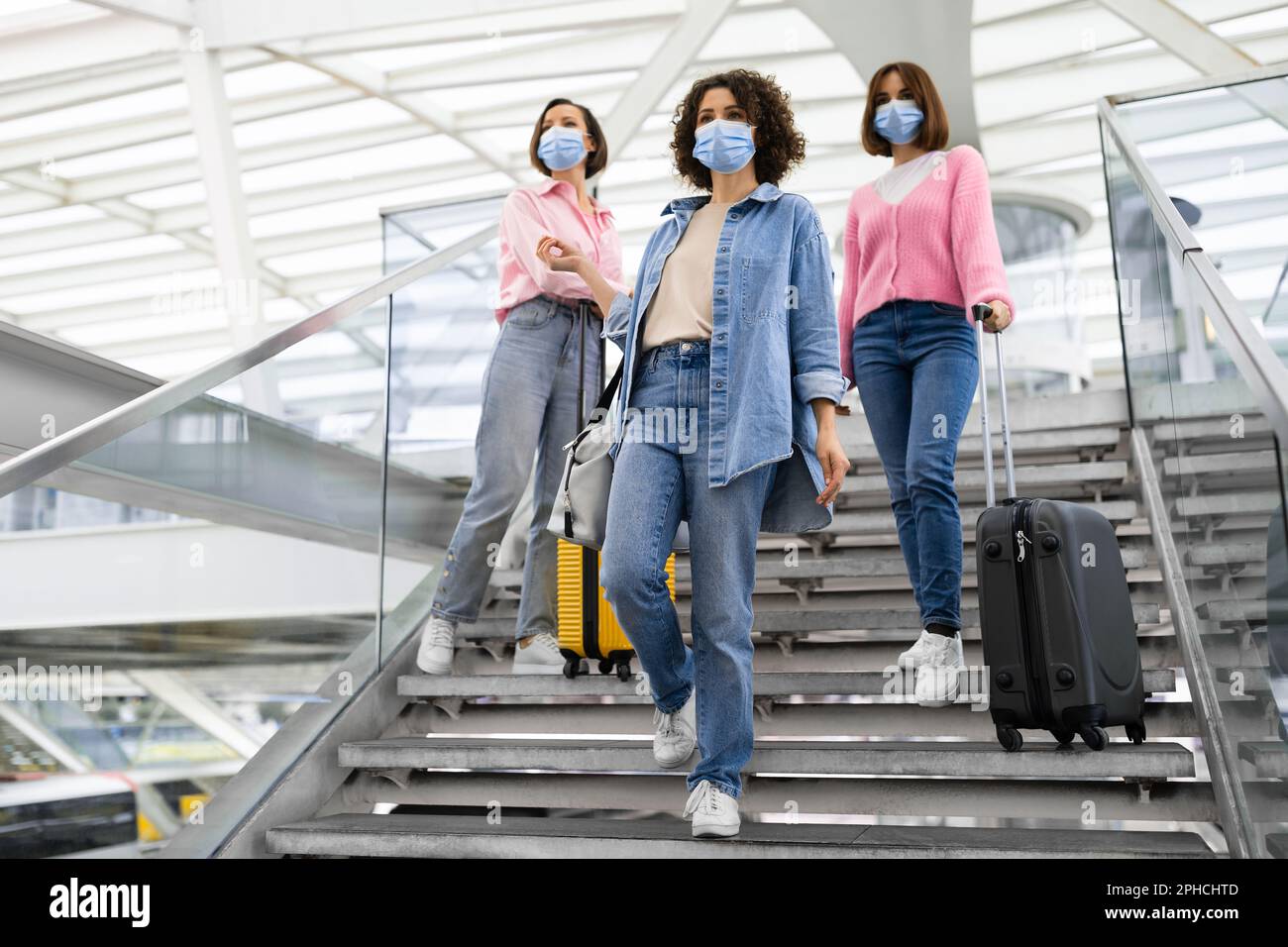 Group Of Women Wearing Protective Face Masks Walking On Stairs At ...