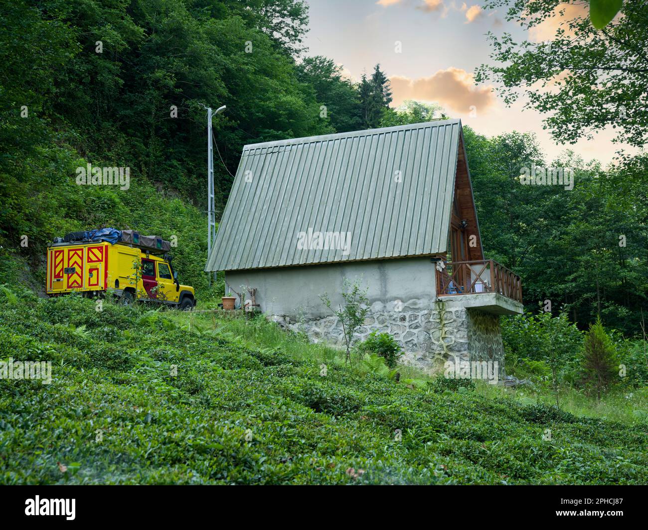 Mountain hut and campervan. Small house in green nature Stock Photo - Alamy