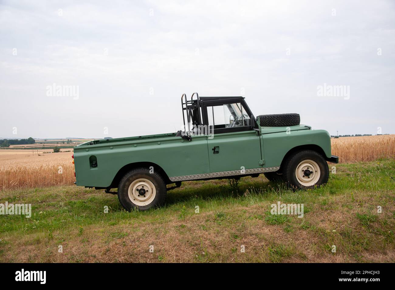 Land Rover Series Three pickup truck with soft top cab parked on grass ...