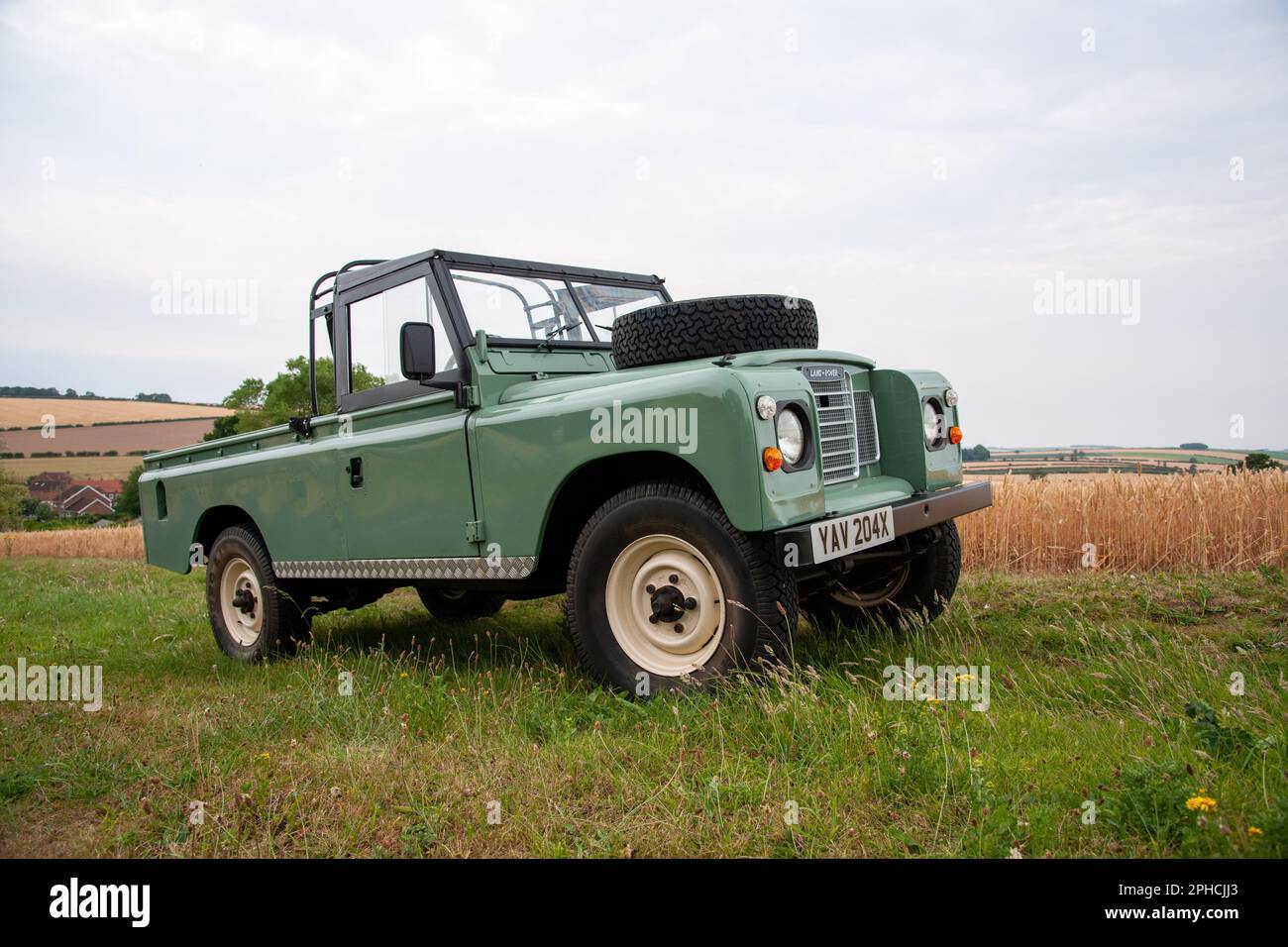 Land Rover Series Three pickup truck with soft top cab parked on grass ...