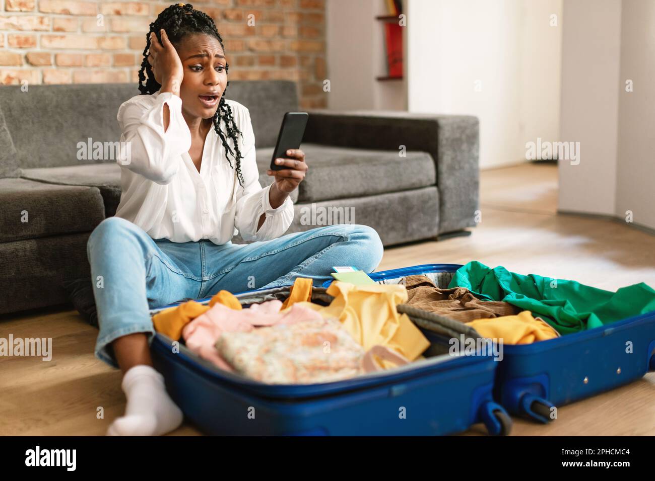 Traveling problems concept. Shocked black woman reading shocking travel ...