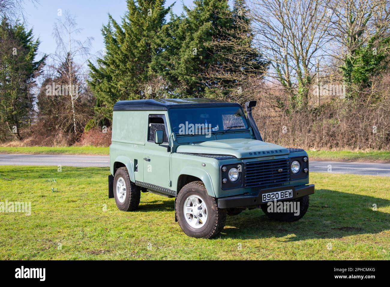 Green Land Rover Defender equipped with five-spoke alloy wheels and ...