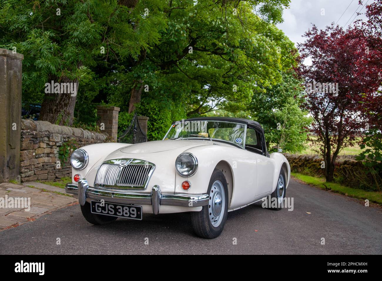 A white MGA roadster British classic car parked on a country lane in ...