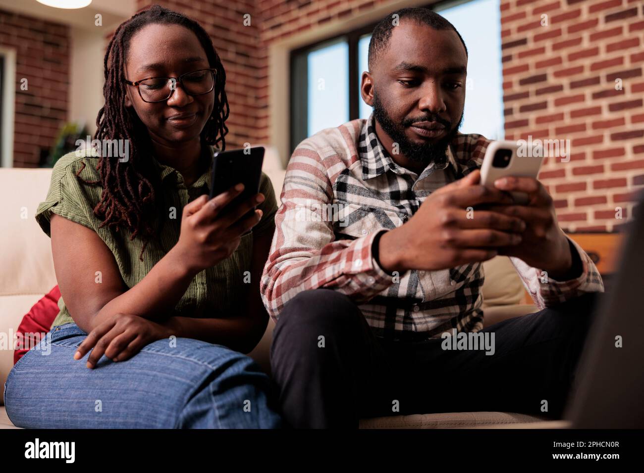 African american couple spending time looking at social media content ...