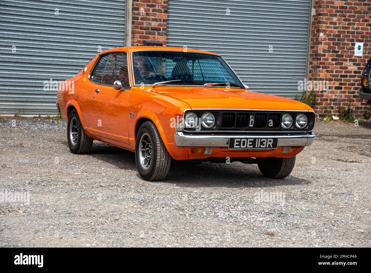 A bright metallic orange 1977 Mitsubishi Colt Galant 1.7 GSstanding in ...