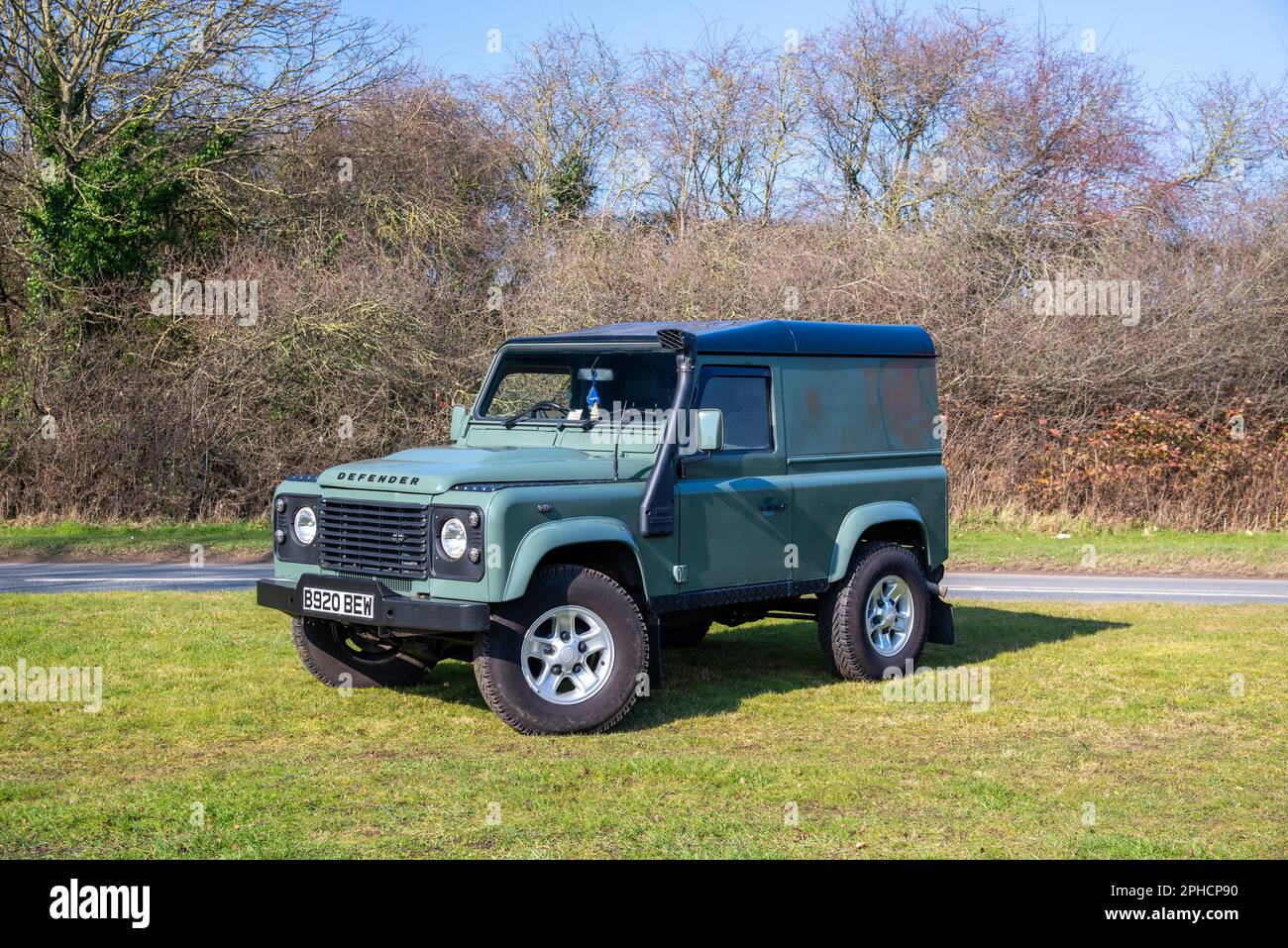 Green Land Rover Defender equipped with five-spoke alloy wheels and ...