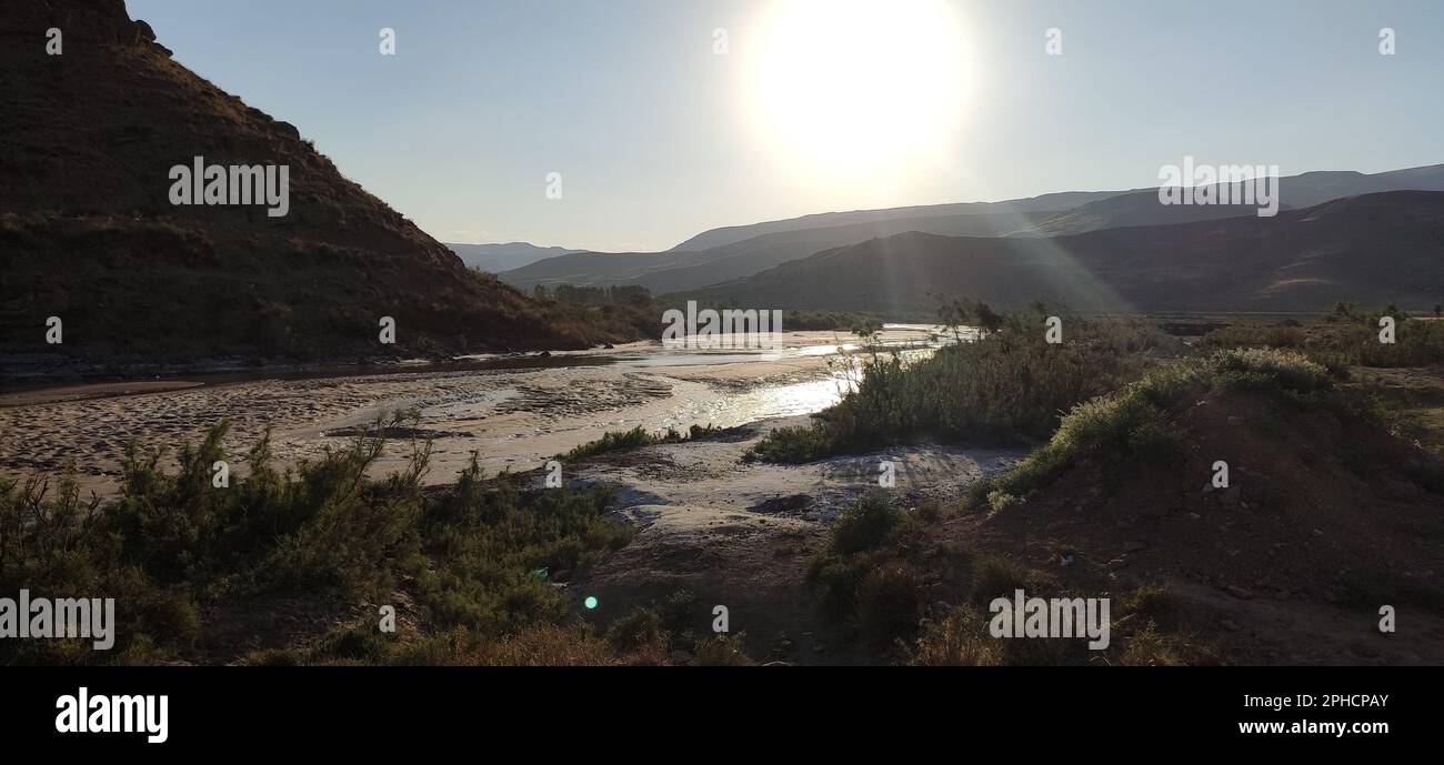 A scenic view of a river stretching across the landscape with mountains ...