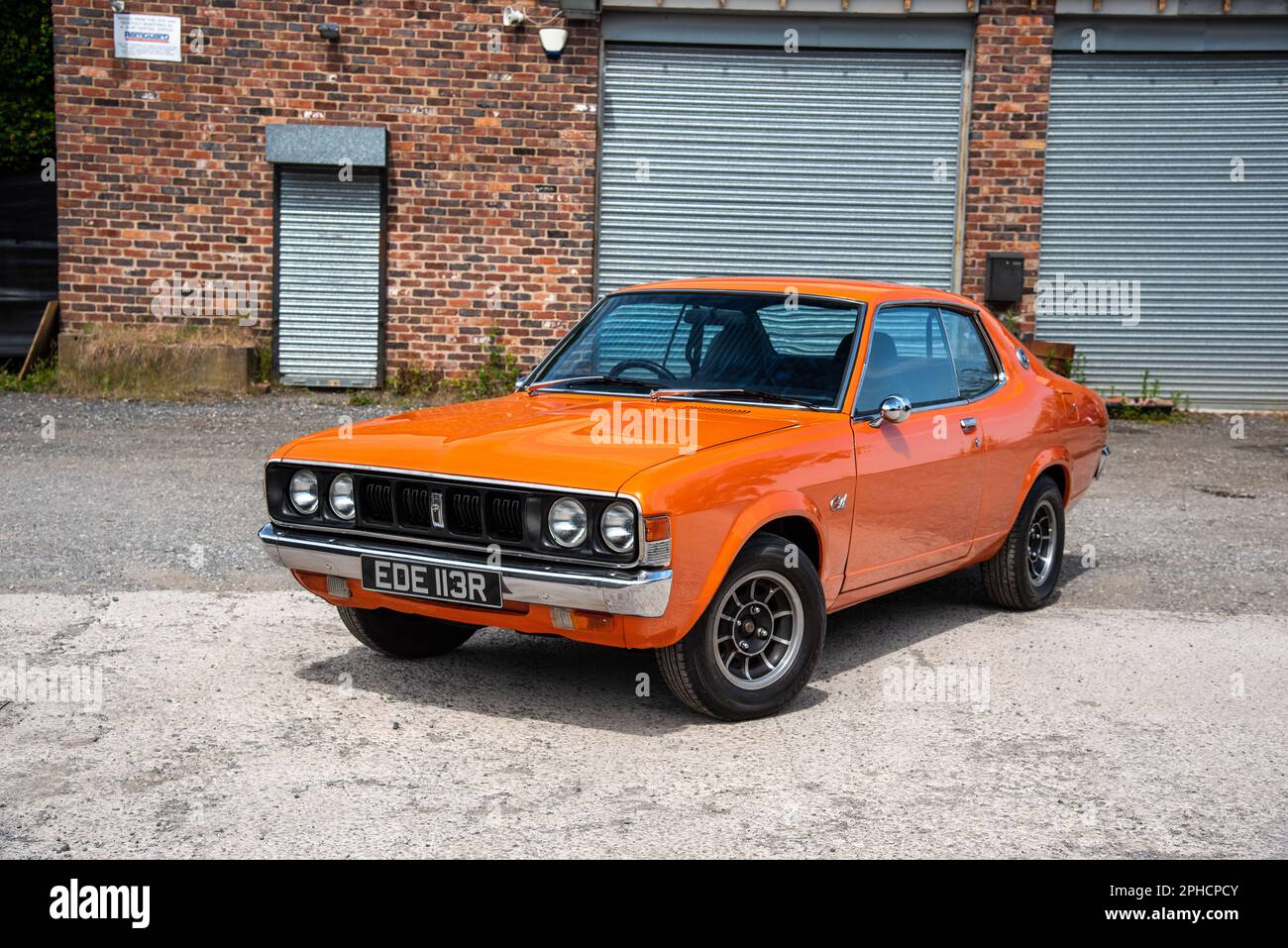 A bright metallic orange 1977 Mitsubishi Colt Galant 1.7 GSstanding in ...
