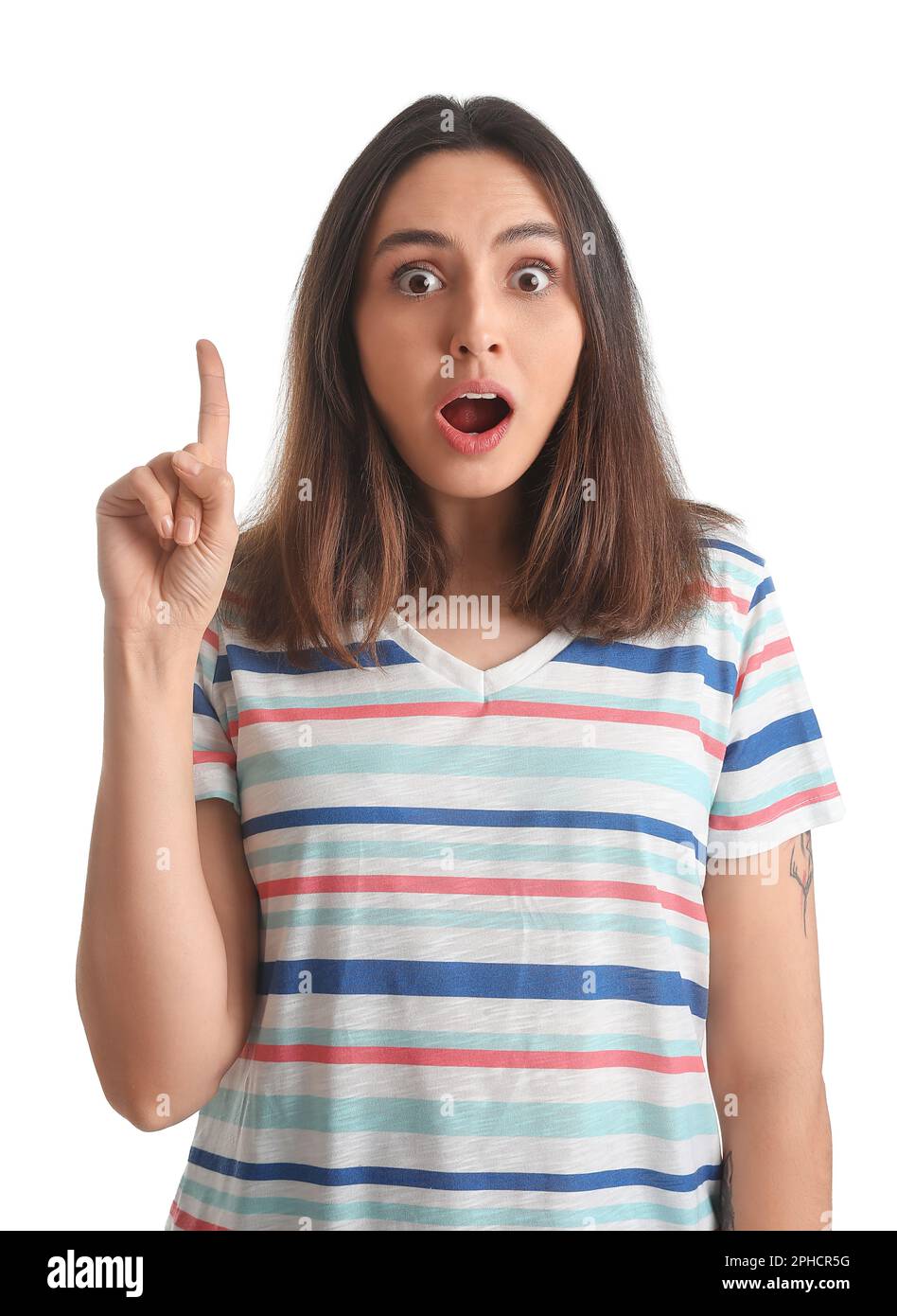 Shocked young woman with raised index finger on white background Stock ...