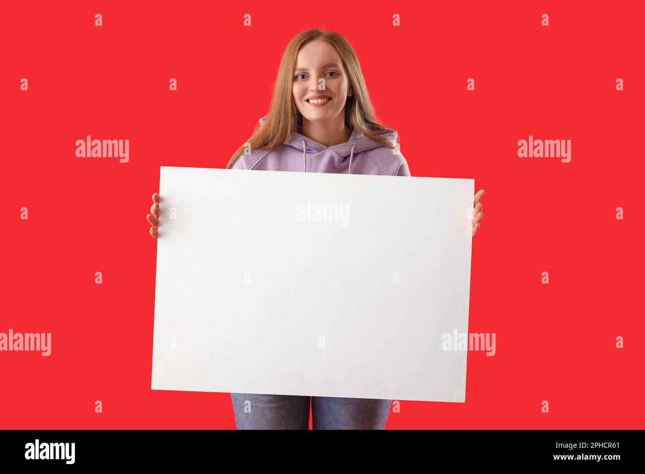 Beautiful woman with big blank poster on red background Stock Photo - Alamy