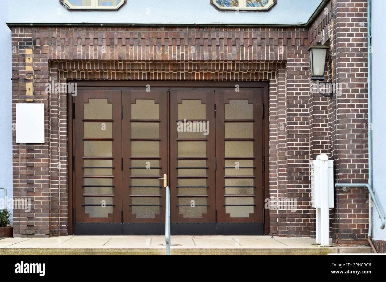 View of brick building with big door Stock Photo - Alamy