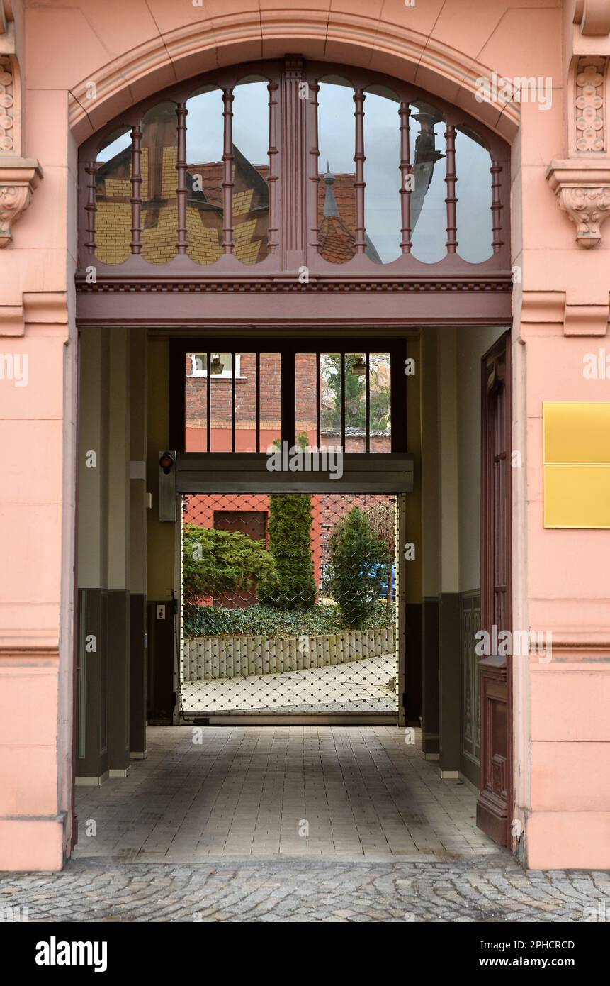 View of city building with open wooden door Stock Photo - Alamy