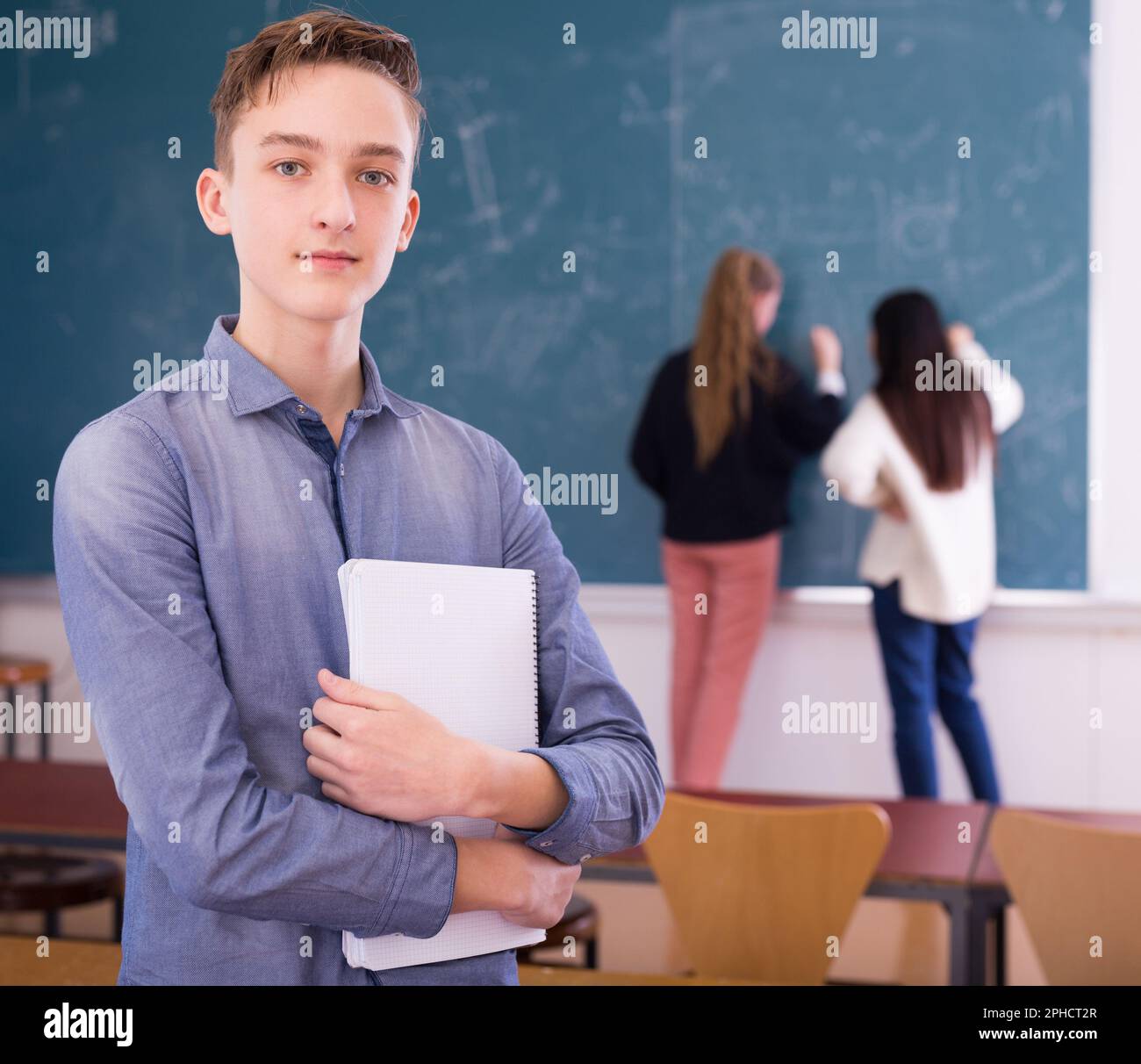 Portrait of guy student holding notebook in auditorium Stock Photo - Alamy