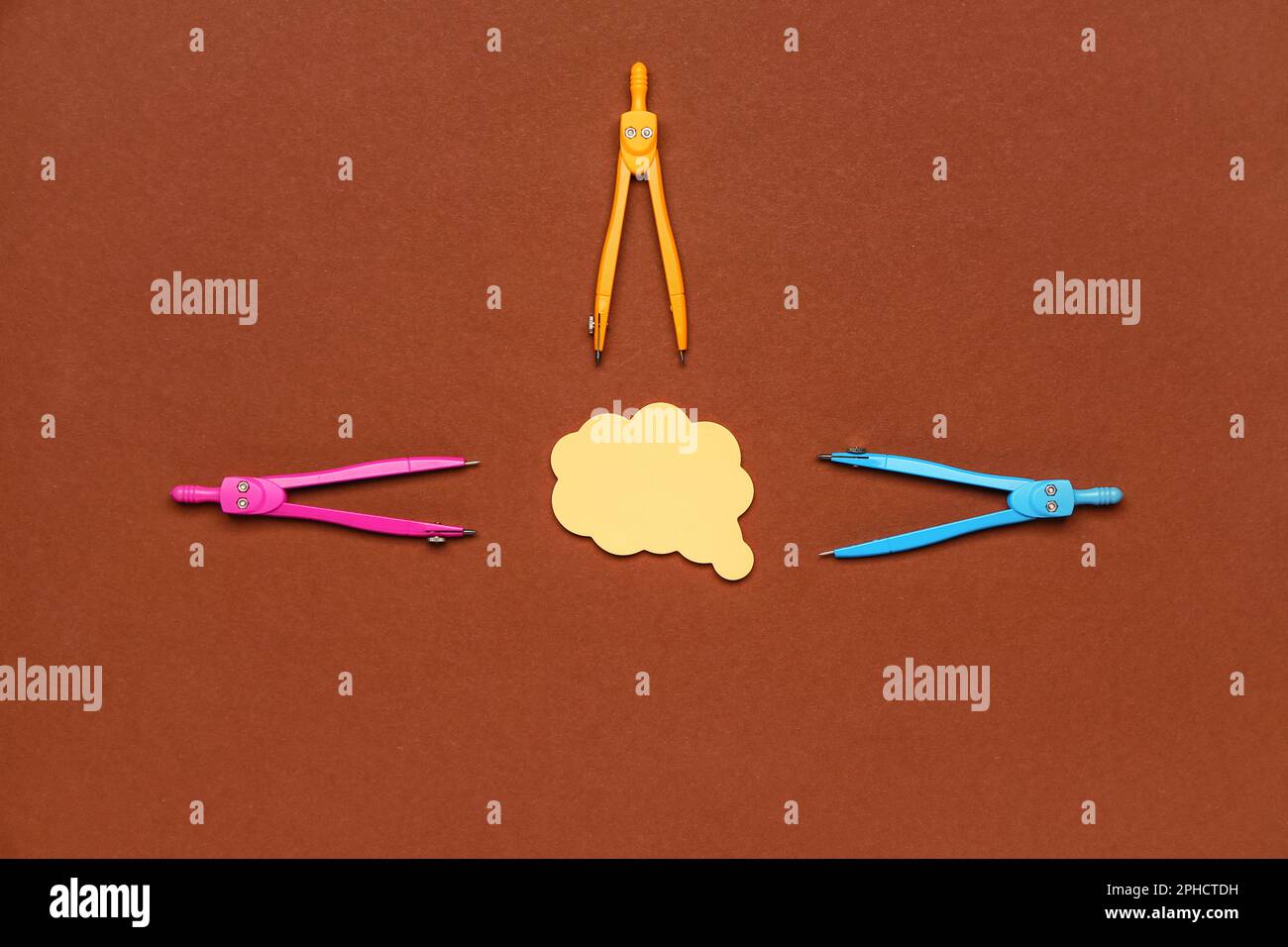 Composition with color drawing compasses and sticky note on brown ...