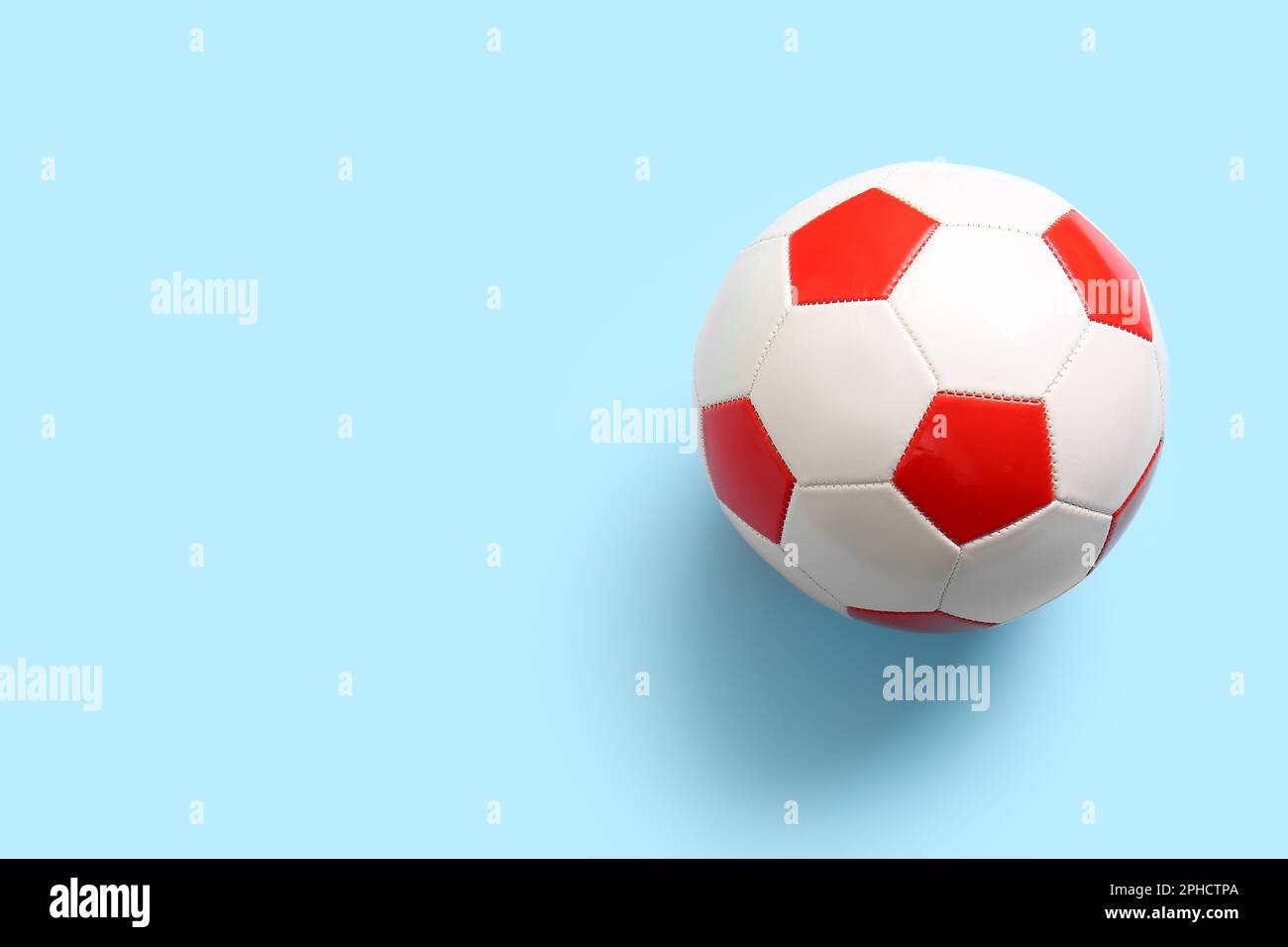 Soccer ball on light blue background Stock Photo - Alamy