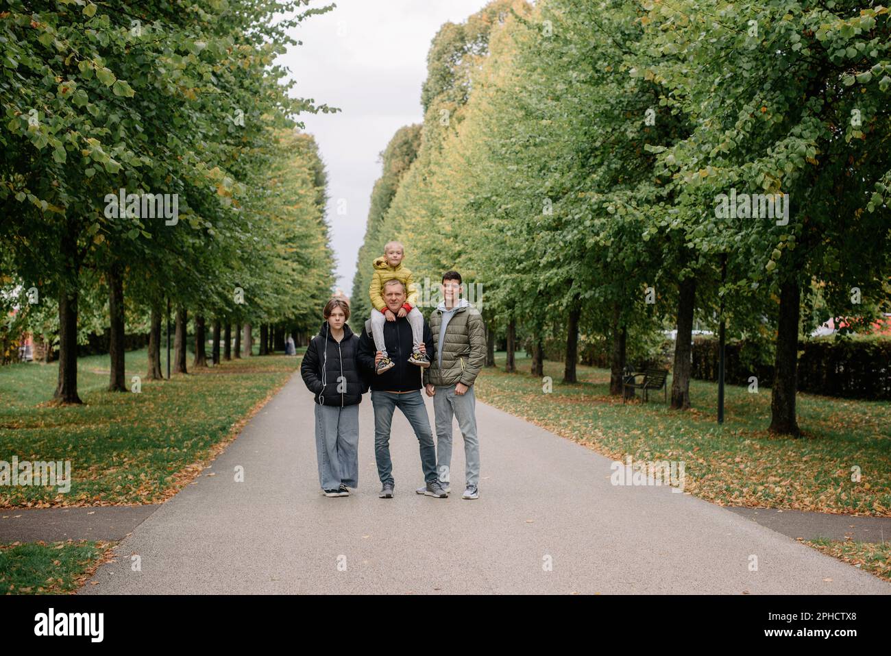 Happy family - Father with three children together in autumn park ...