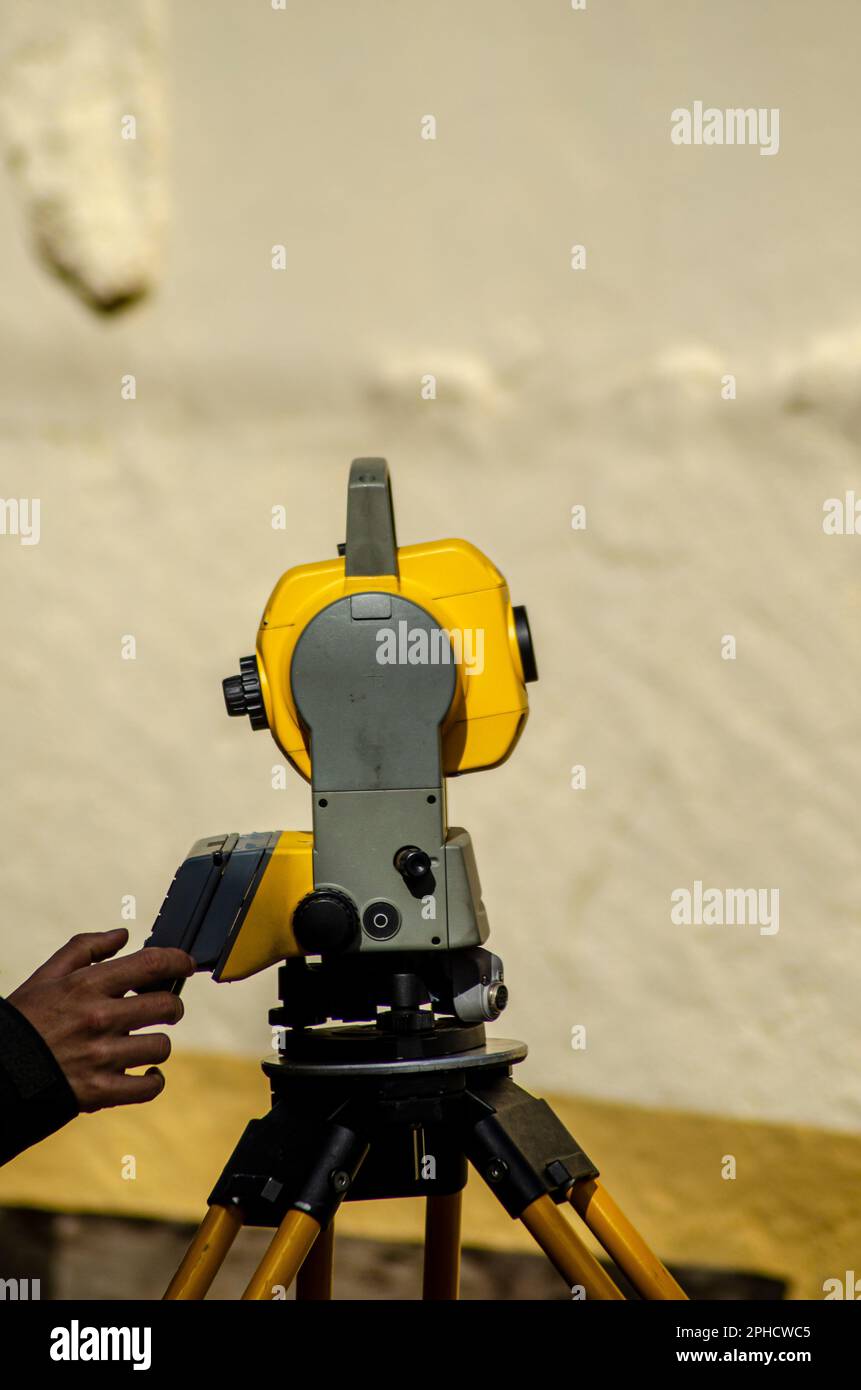 An engineer's hand using a total station for topographic measurements ...