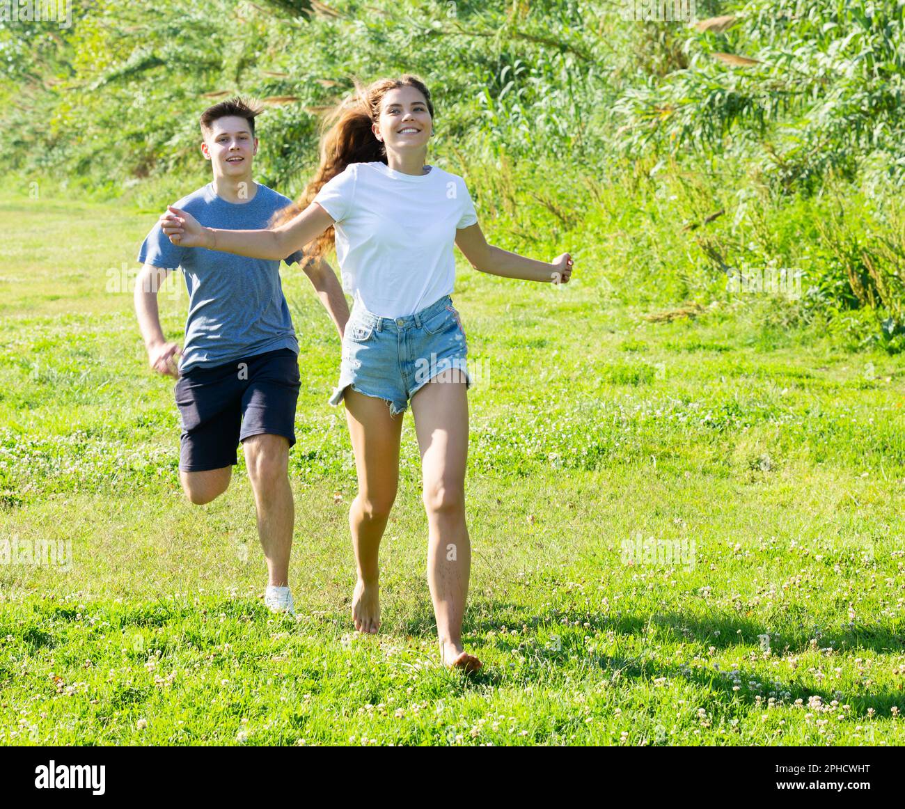 Two teenagers running boy girl hi-res stock photography and images - Alamy