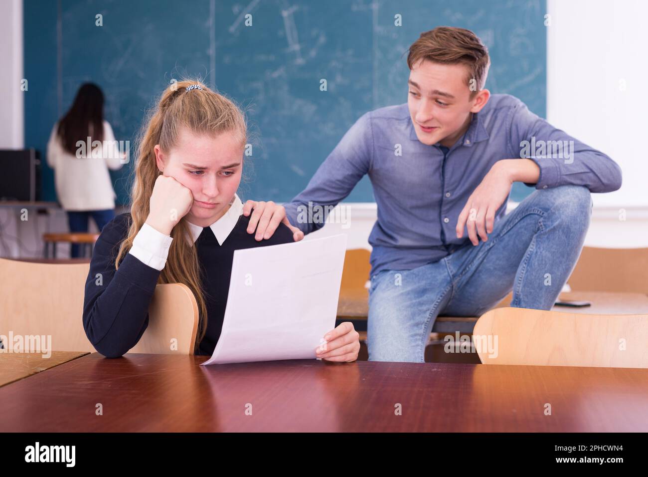 Teenager soothing girl classmate over failure of exam Stock Photo - Alamy