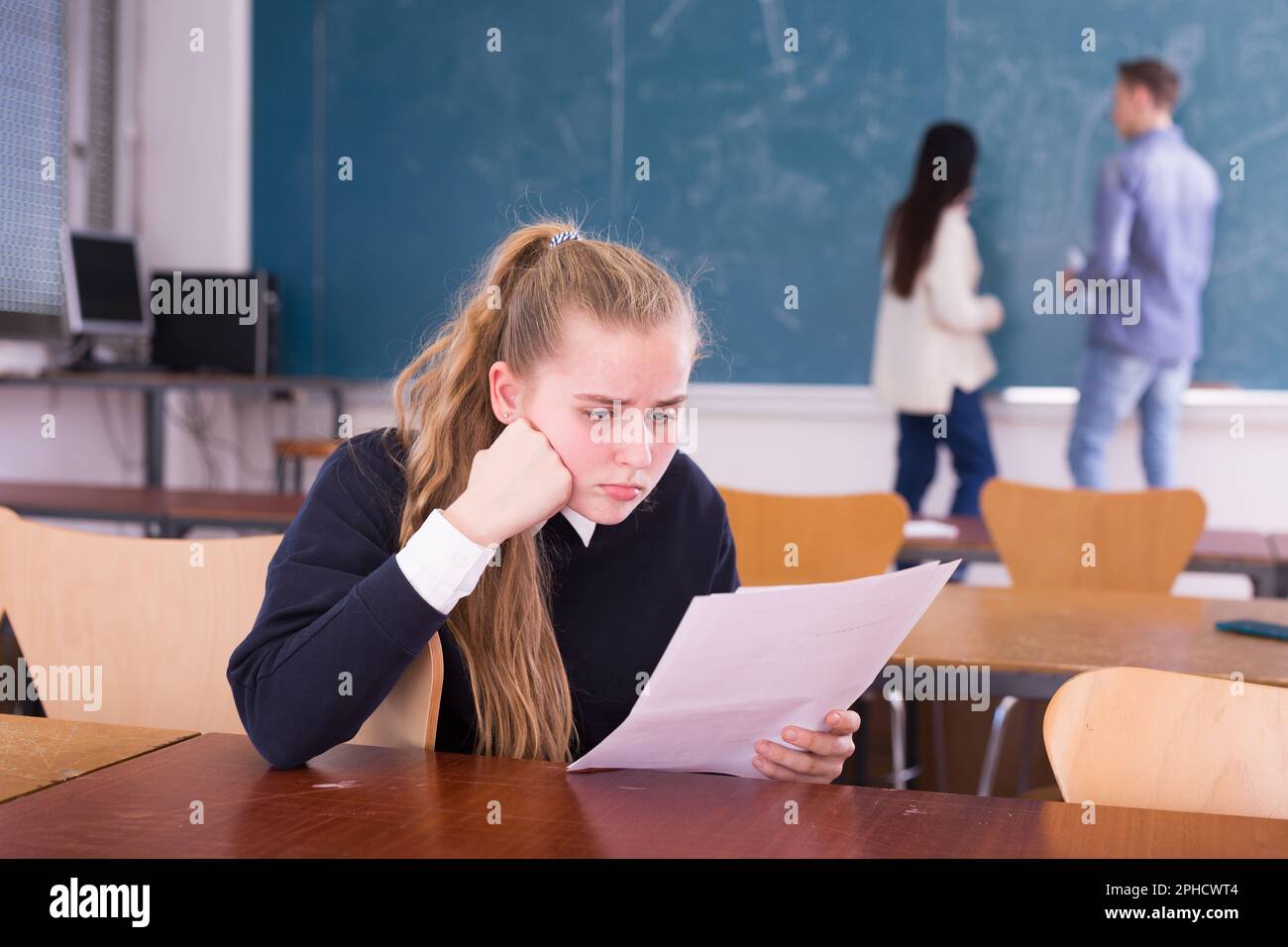 Young sad girl preparing for the exam in classroom Stock Photo - Alamy