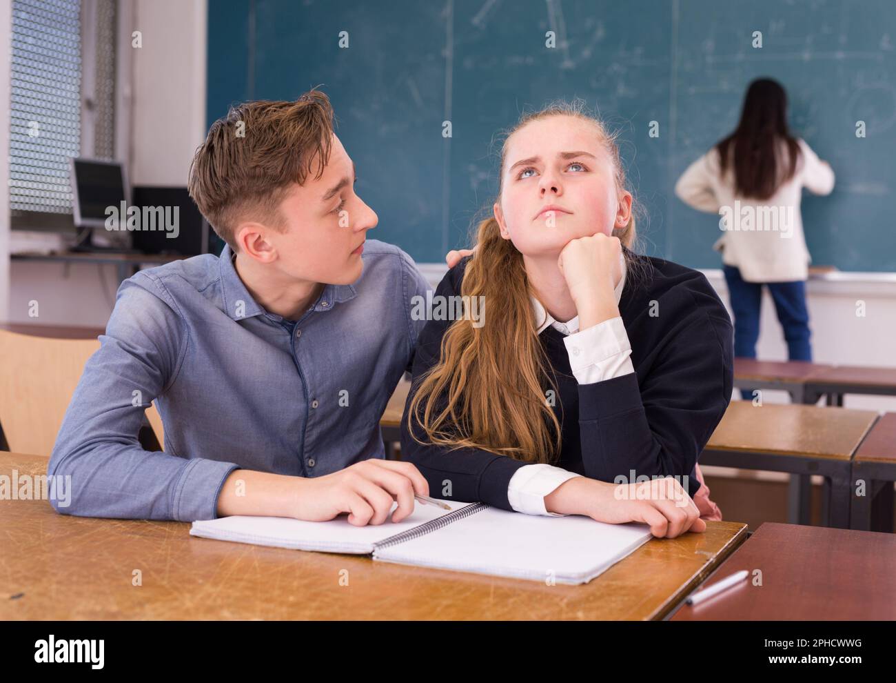 Teenager supporting female classmate Stock Photo - Alamy